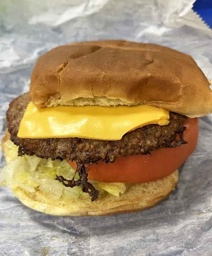 A proper cheeseburger with lettuce, tomato, and melted cheese &mdash; no gimmicks, just exactly what you wanted.