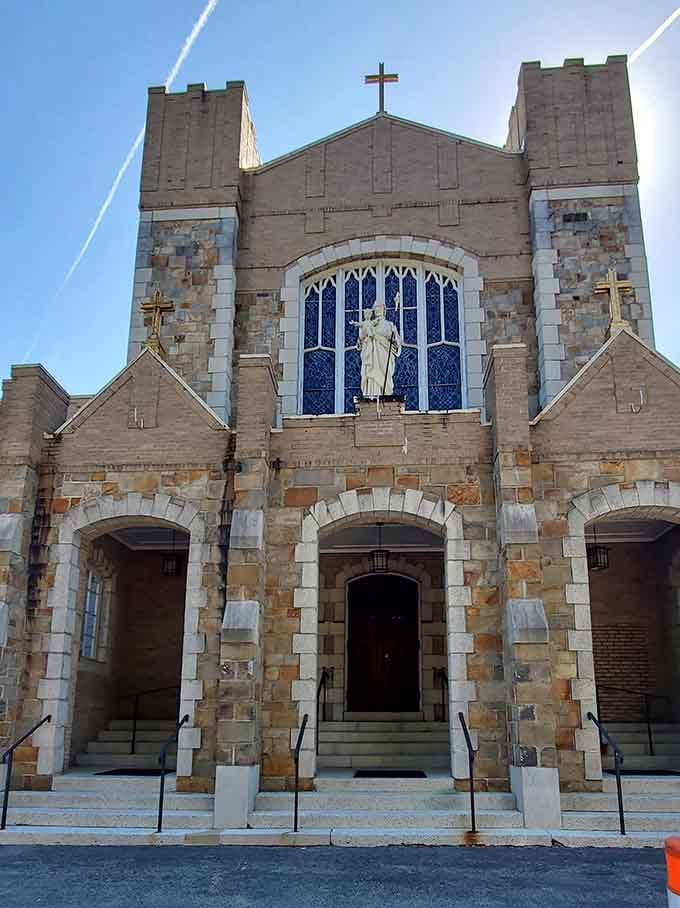Stone church facade with Gothic arches and stained glass that's been anchoring the community through generations of change.