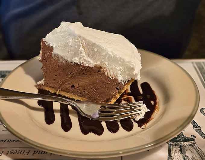 Chocolate cream pie with whipped topping and a chocolate drizzle. Dessert doesn't need to explain itself here.