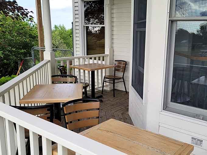 A wraparound porch with tables and fresh air. This is what a perfect afternoon looks like in northern Michigan.