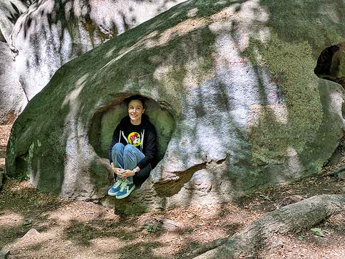 Tucked inside a natural rock hollow, this smiling visitor found Charlotte's coziest seat that no furniture store could ever sell.