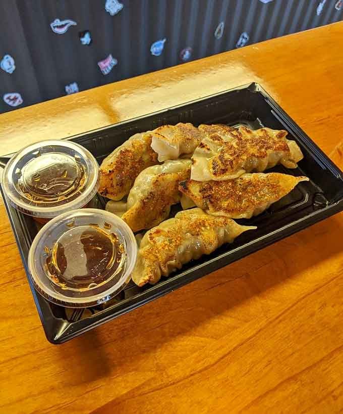 Six pan-fried gyoza, golden and crispy, served with dipping sauce. At a burger joint, this is the plot twist nobody saw coming.