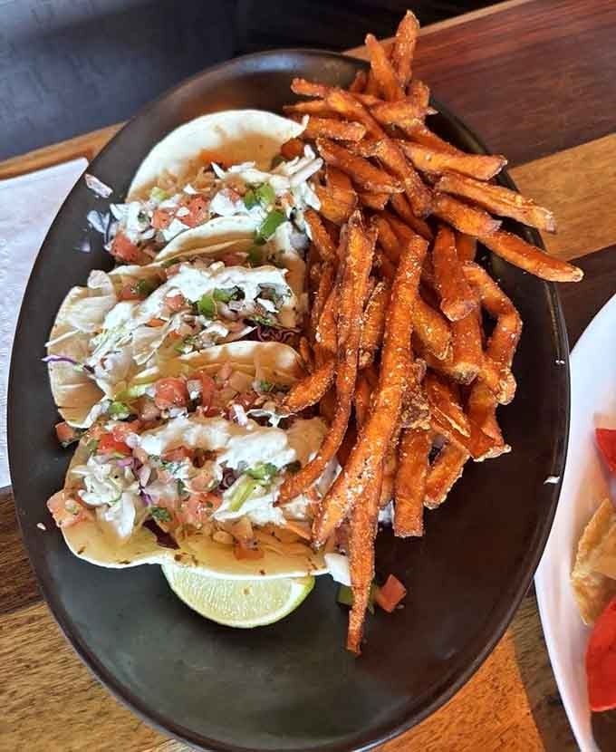 Fish tacos with fresh pico, slaw, and a squeeze of lime, paired with sweet potato fries that deserve their own fan club.