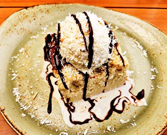 Tres leches cake drizzled with chocolate and topped with whipped cream makes dessert decisions dangerously easy.