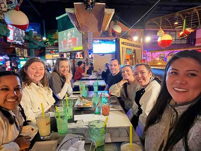 Happy diners with colorful drinks prove that good food and great atmosphere create memories worth capturing and sharing forever.