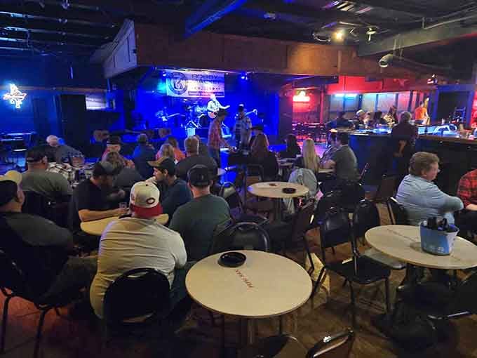 Live music fills the room as folks settle in, proving life and entertainment continue despite the legends.