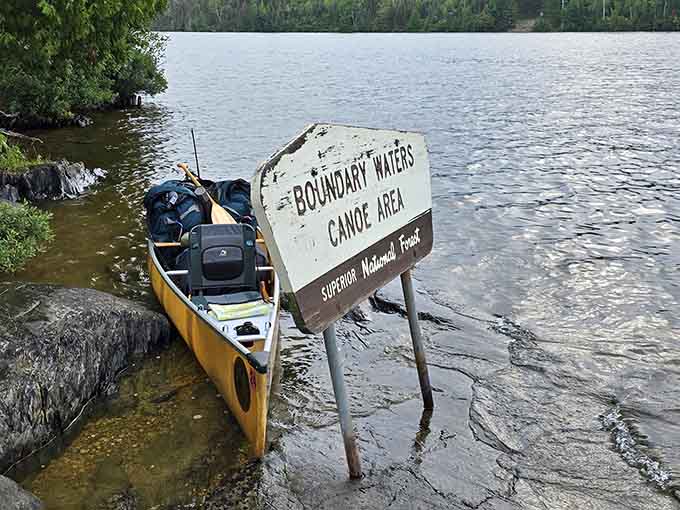 The sign says Boundary Waters Canoe Area, but your heart reads it as the beginning of something unforgettable.