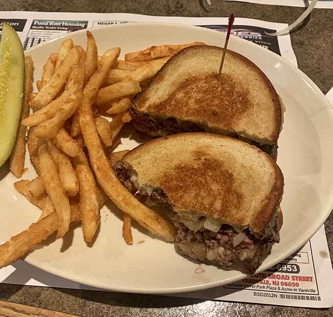 A patty melt on toasted bread with golden fries, simple, honest, and completely impossible to resist.
