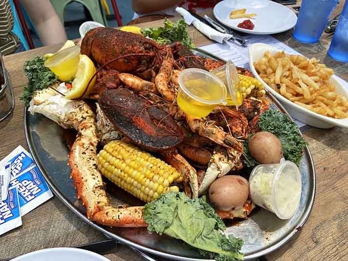 The Brooklyn Crab Royale arrives like a seafood parade on a platter. Snow crab legs, whole lobster, shrimp, corn, and potatoes all together.