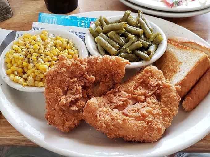 Golden fried catfish, seasoned corn, tender green beans, and toast &mdash; a plate that makes you feel genuinely taken care of.