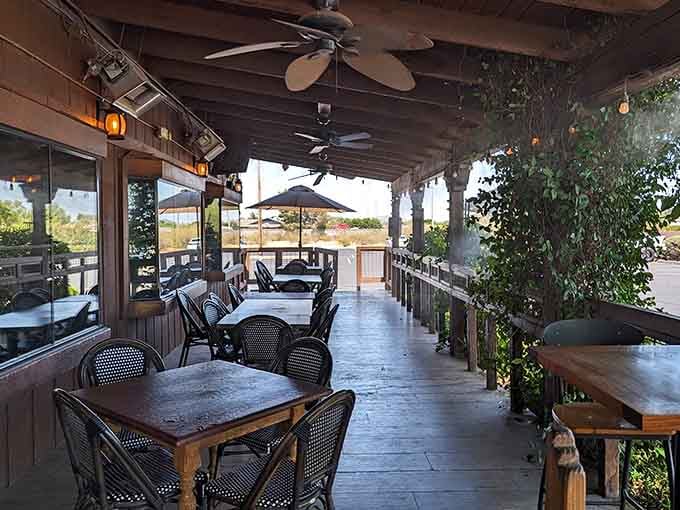 A covered porch with ceiling fans and string lights. Arizona evenings were practically invented for dining right here.