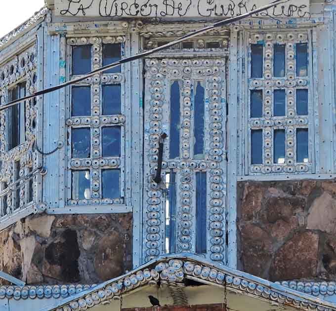 "La Virgen de Guadalupe" written above windows framed in bottle caps, where faith and folk art become the same beautiful thing.