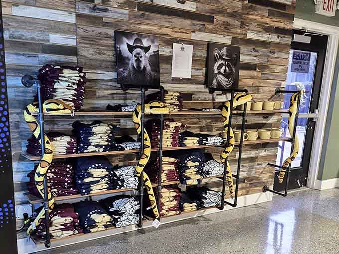 Capybara Cafe merch lines the rustic shelves, because of course you're leaving with a souvenir today.