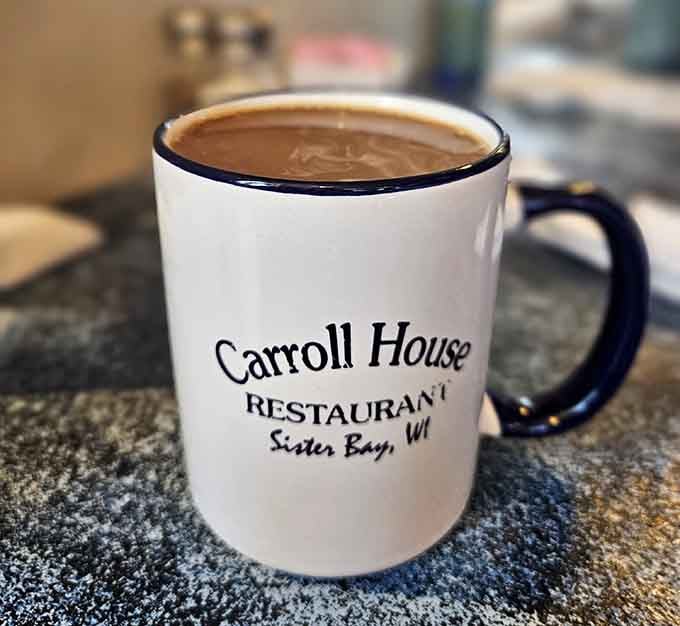 Strong coffee served in their own branded mugs because even the caffeine delivery system matters here somehow.