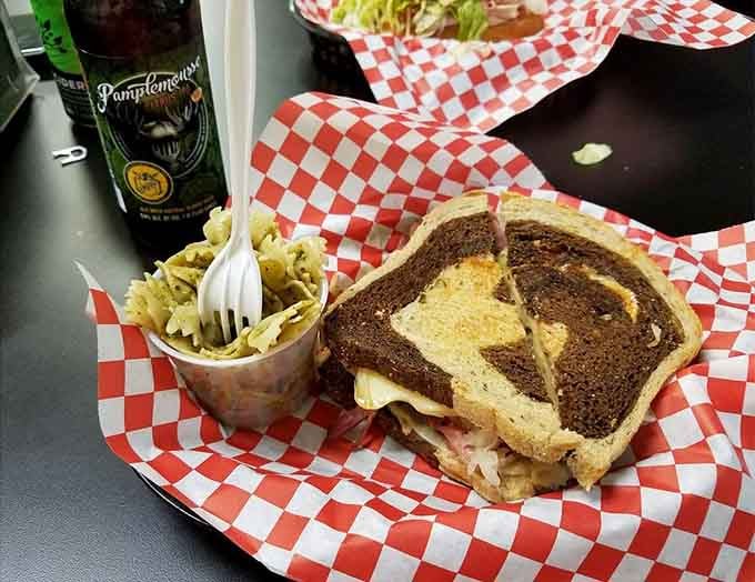 The Reuben arrives on marble rye with pesto pasta alongside, a meal that deserves your full attention.