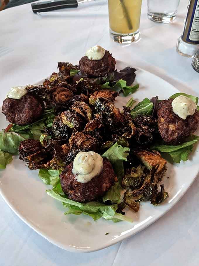 Crab bites with fried brussels and dollops of sauce turn appetizers into the main event worth celebrating.