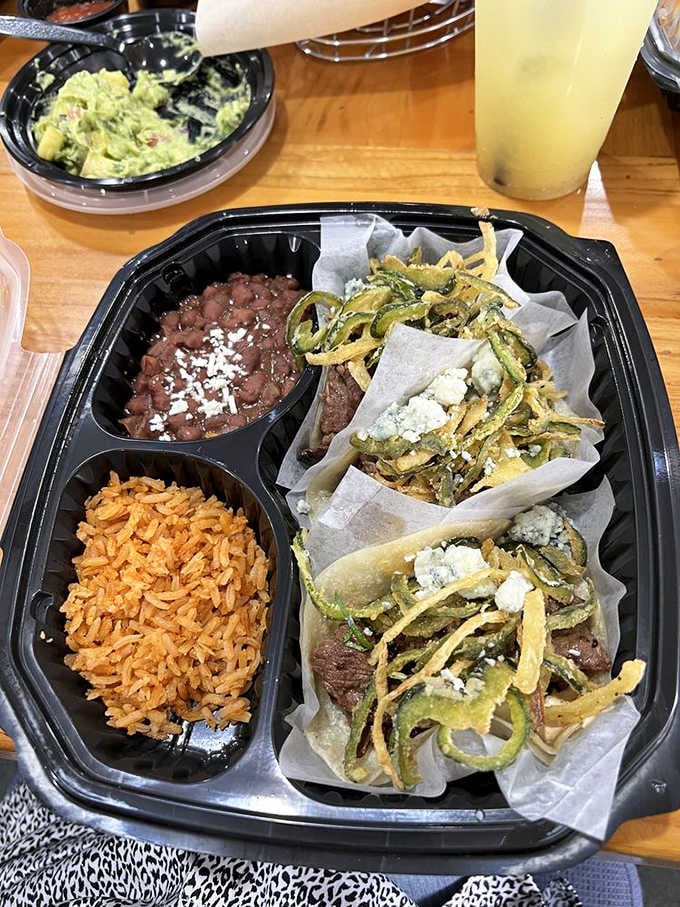 Beef tenderloin steak tacos loaded with fried peppers and gorgonzola, arriving in a takeout tray that deserves a standing ovation.