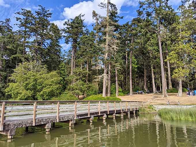 A quiet wooden pier, pink wildflowers, and glassy water. Deception Pass has range, people.