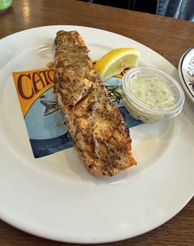 Grilled salmon with that beautiful char and a wedge of lemon, proving healthy eating doesn't mean sacrificing flavor.