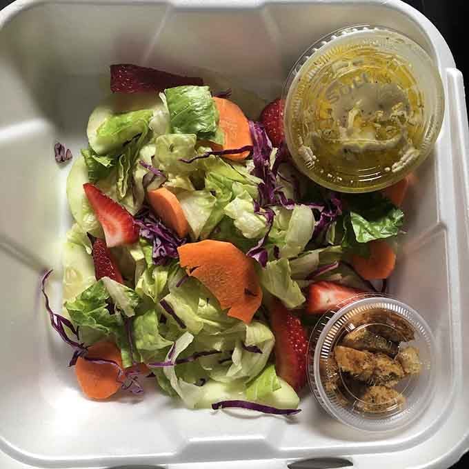 Even the salads here come with personality—fresh, colorful, and probably feeling a little out of place among the chili.