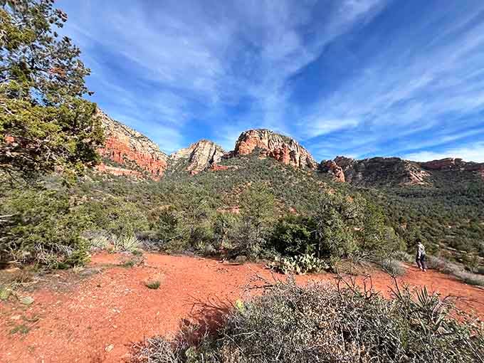 Wide open views stretching toward the horizon, with red rock formations rising like nature's own skyline.