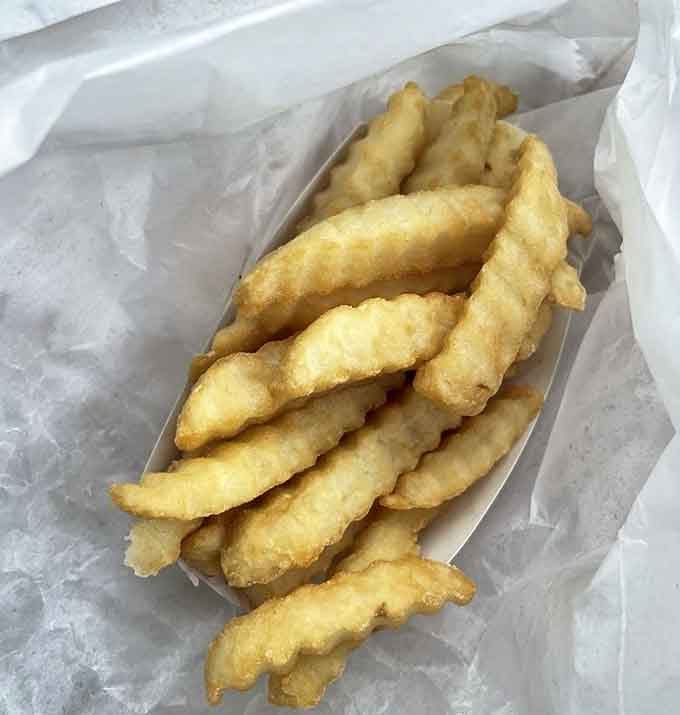 French fries with that perfect crinkle-cut texture, golden and ready to make all your other life choices seem less important by comparison.