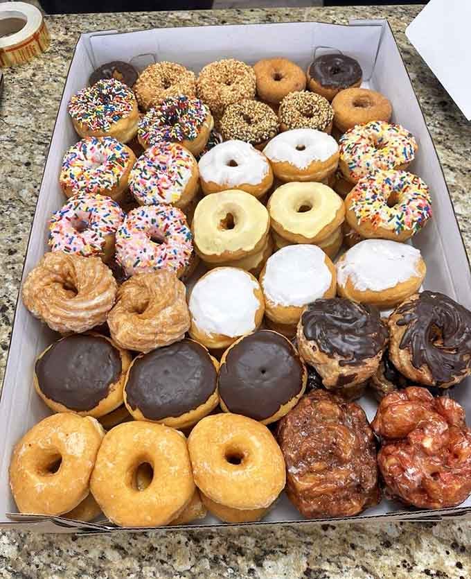 A donut assortment this beautiful makes choosing just one flavor feel like an impossible mission worth accepting anyway.