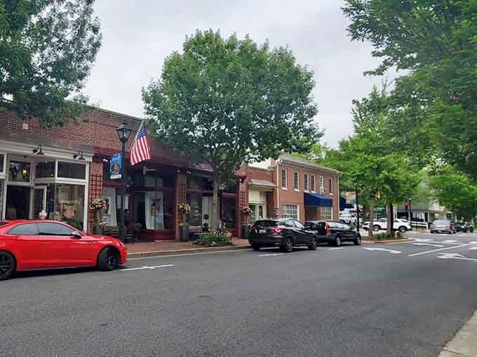 American flag flutters above storefronts where parking is easy and nobody honks at you for taking your time.