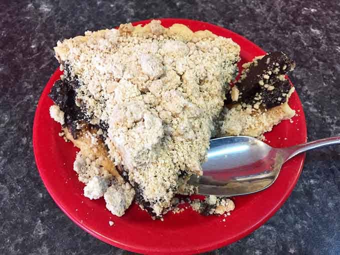 A slice of pie with a crumbly topping so generous it practically needs its own zip code.