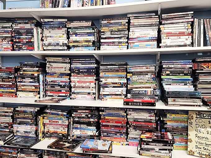 DVDs stacked to the ceiling like a beautiful, chaotic monument to movie nights gone by.