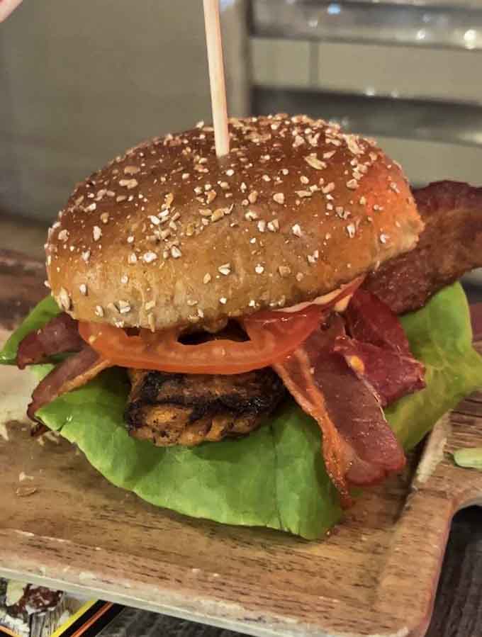 Grilled salmon with fresh toppings on a seeded bun proves Flamme Burger thinks way beyond beef.