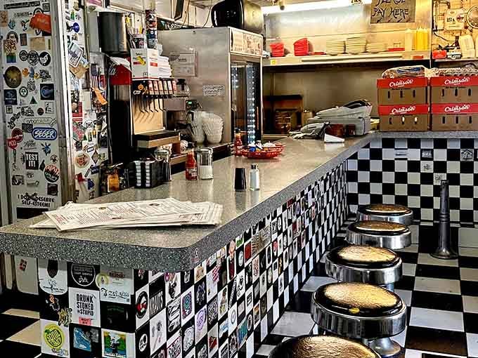 Classic counter stools, a checkered facade, and a kitchen that never stops moving. This is diner culture at its finest.