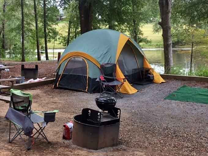 A tent, a fire pit, and a lake view, this campsite is what people mean when they say "living well."