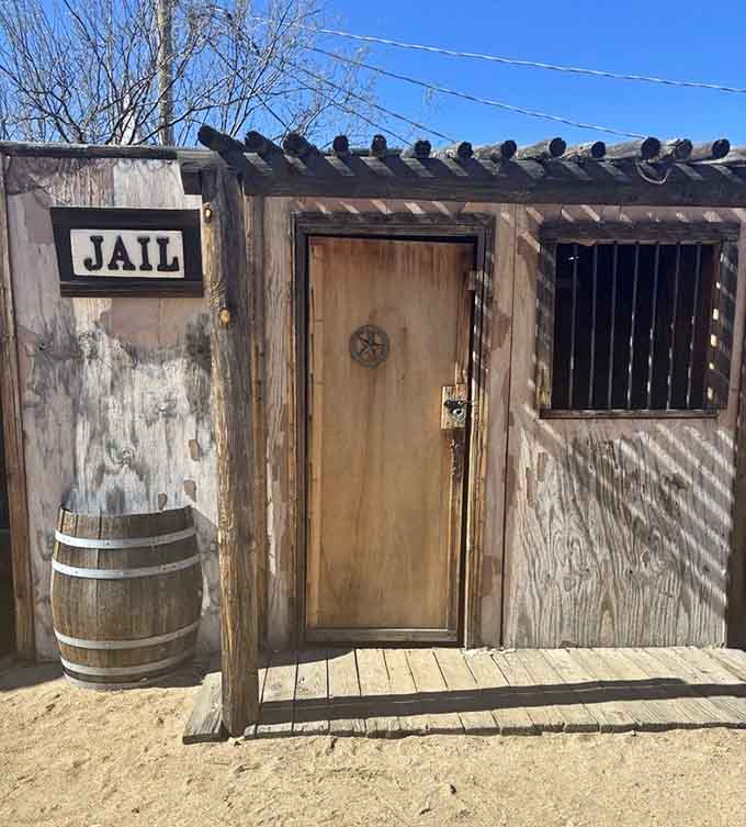 A proper Old West jail, complete with iron bars and a barrel out front for maximum dramatic effect.