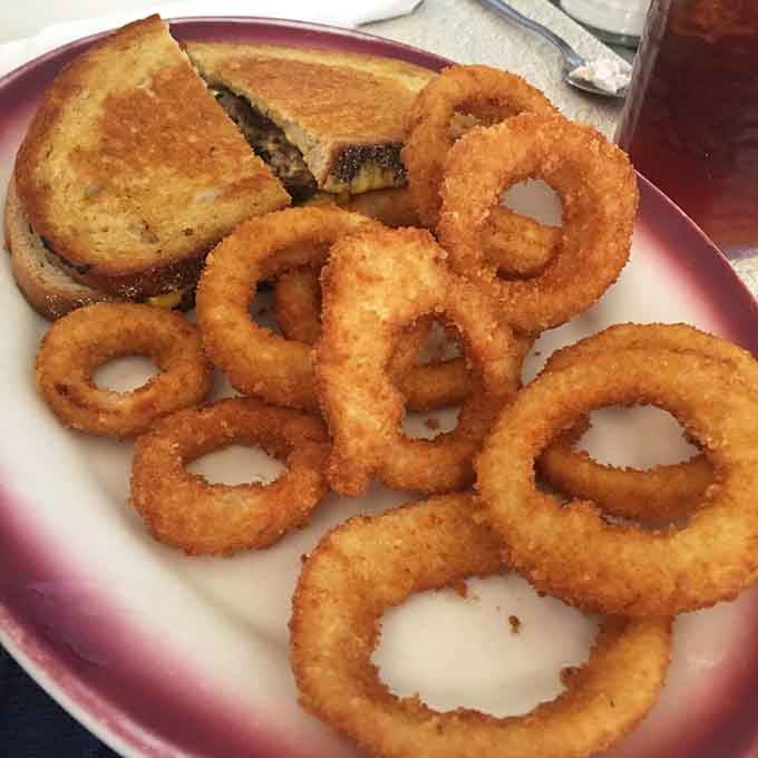 A patty melt and a mountain of golden onion rings. Simple pleasures, executed with complete confidence.