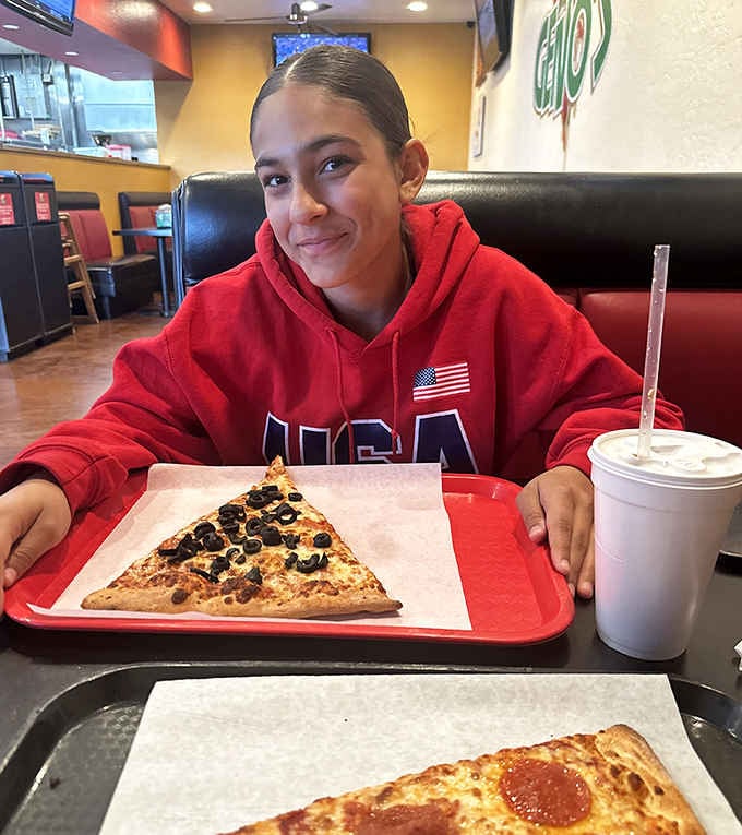 That smile says everything. When the pizza is bigger than your expectations, happiness is the only reasonable response.
