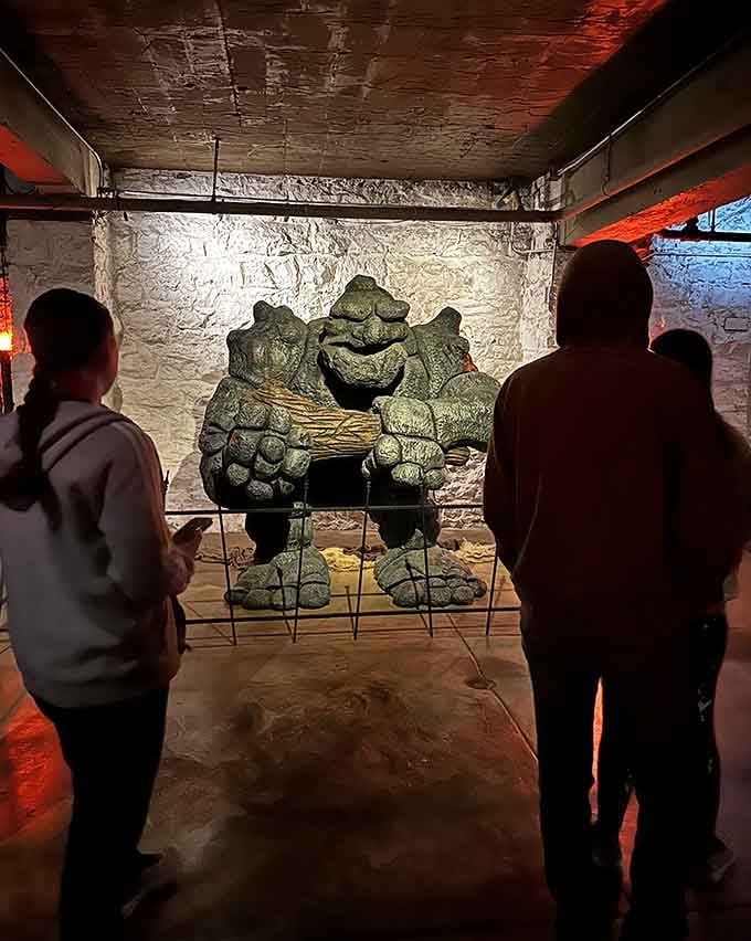 Tour groups gather in the basement's eerie glow, where that statue looks suspiciously like it just moved when you weren't looking.