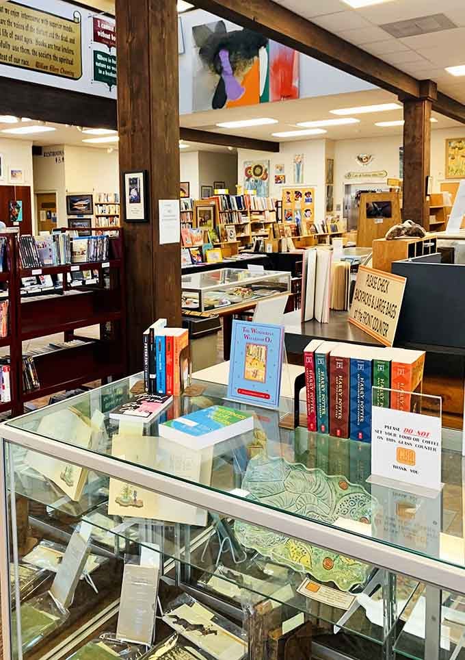 Rare finds under glass, colorful art overhead, and a Harry Potter set just sitting there, judging your reading list.