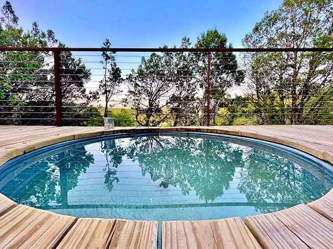 That circular dip pool sitting on the deck is quietly the most inviting thing in the entire Hill Country.