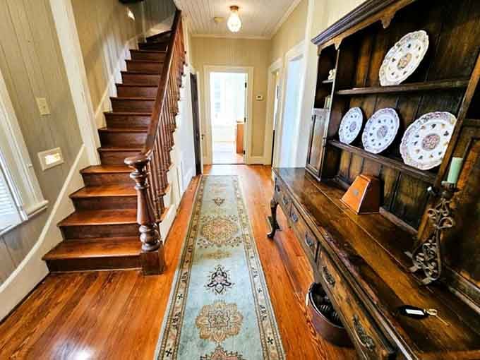 That staircase and antique hutch greet you like a proper Southern host, minus the sweet tea but full of character.
