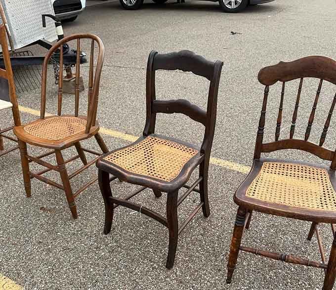 Three vintage cane-seat chairs sitting outside, quietly hoping someone gives them a second act.