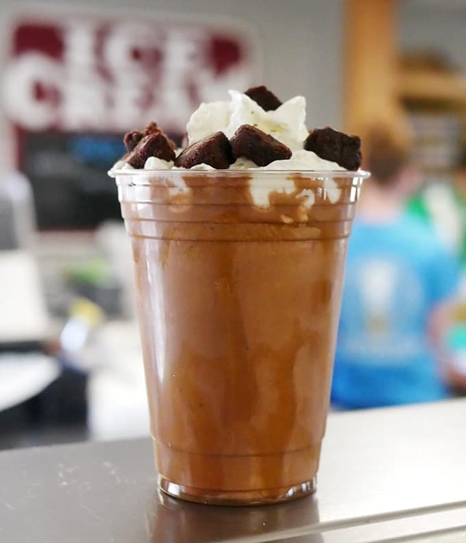 Chocolate shake loaded with brownie chunks and whipped cream, because sometimes dessert needs to be taken seriously as a life choice.