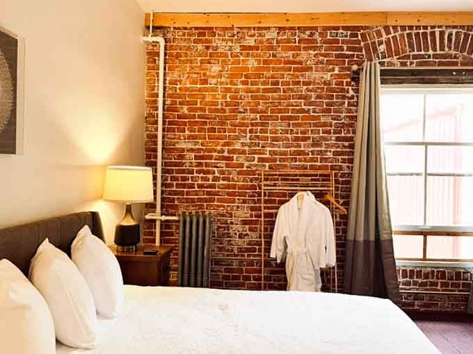 Exposed brick, a fluffy robe, and soft white pillows. History never looked this comfortable.