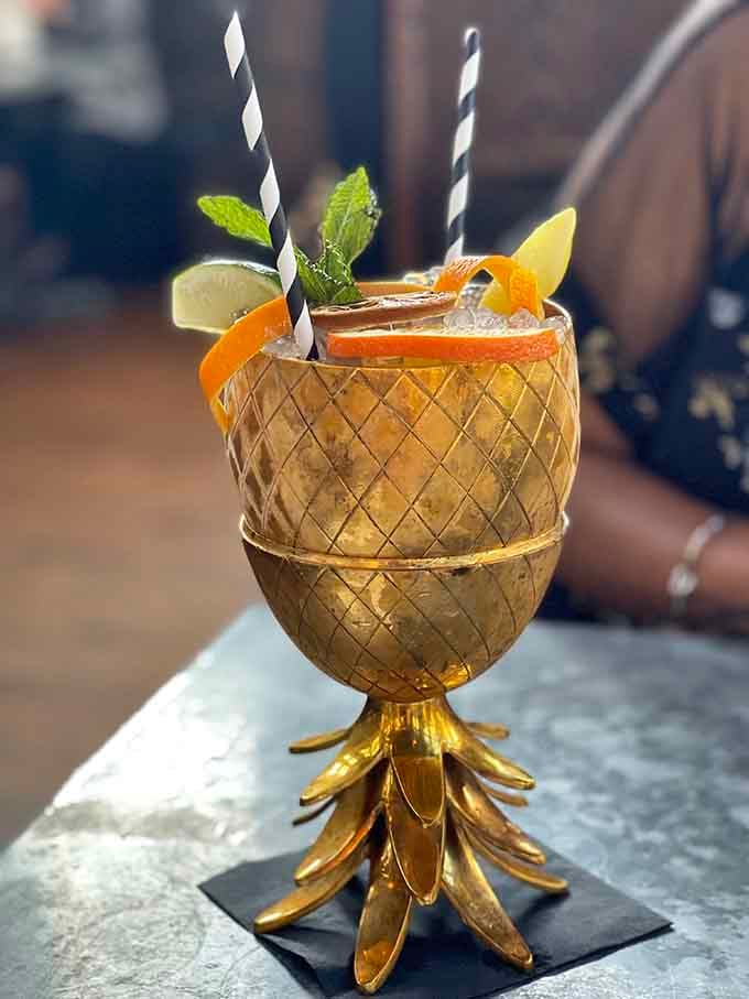 When your cocktail arrives in a golden pineapple cup, you know this bar is playing a completely different game.