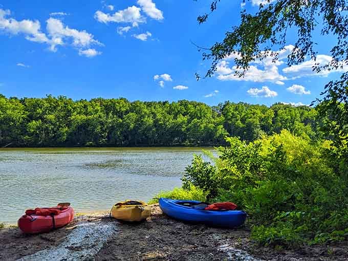 Three kayaks waiting patiently on the rocks. The river is right there. What are you waiting for?