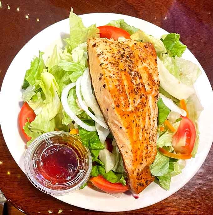 Grilled salmon on a fresh garden salad. Proof that Joe's Inn knows its way around lighter fare too.