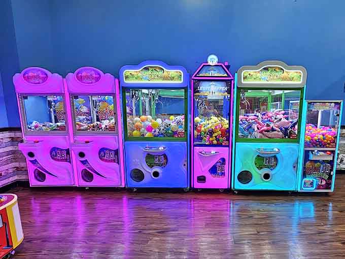 A glowing row of claw machines, because every great adventure deserves a colorful souvenir at the end.