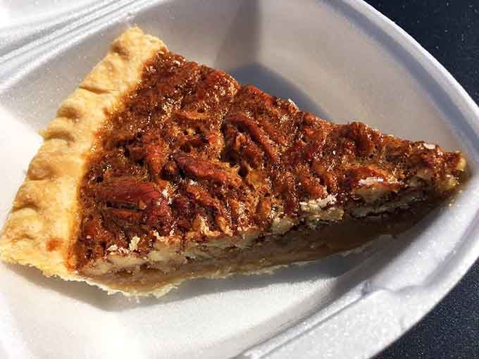 That pecan pie slice is the kind of dessert that makes you reconsider every life decision that almost led you somewhere else.
