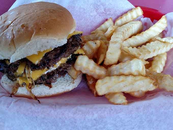 Two patties, melted cheese, and crinkle fries in a red basket: this is what happiness looks like.