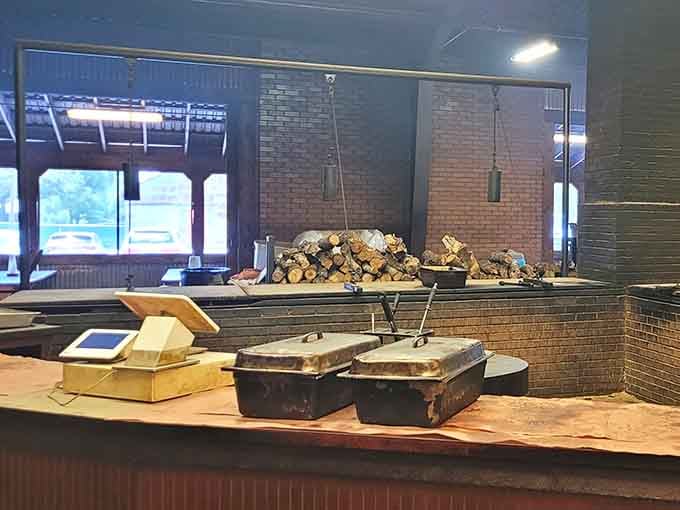 Stacked post oak logs behind the counter, ready for duty. This is where the real magic quietly gets to work.